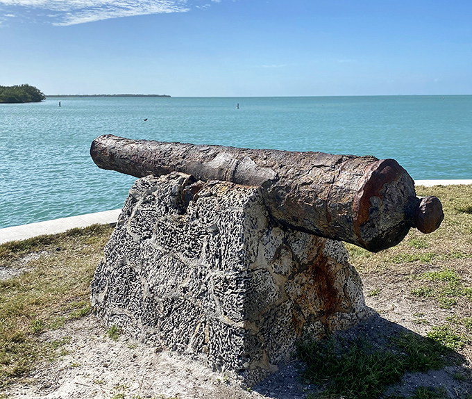 This weathered cannon hasn't fired a shot in decades, but still commands attention as it stands guard over waters that shimmer like liquid diamonds.