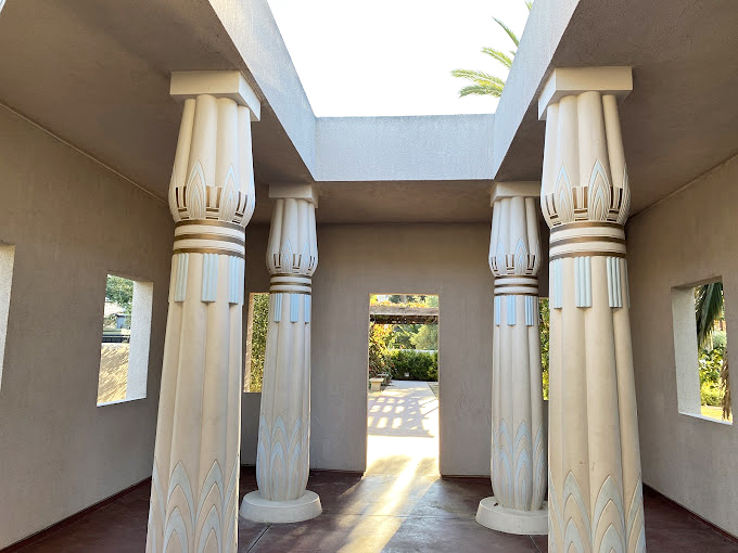 Columns adorned with lotus capitals create a passageway that would make Cleopatra feel right at home. Ancient Egypt meets California sunshine in perfect harmony.
