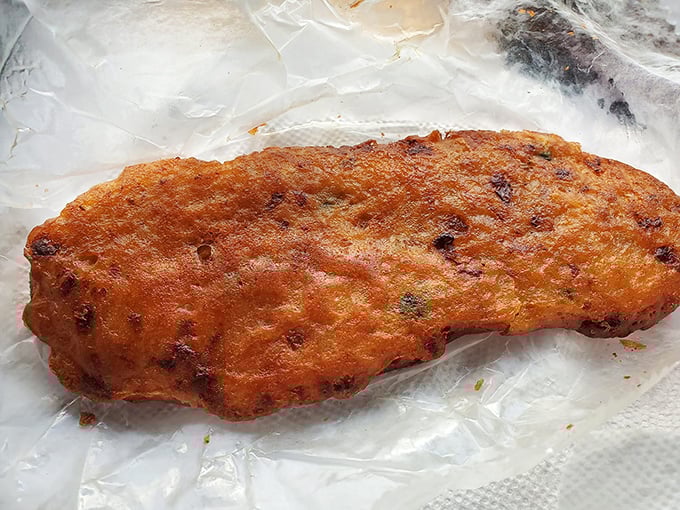 Behold the golden-brown masterpiece that's ruined every other conch fritter for thousands of happy customers.