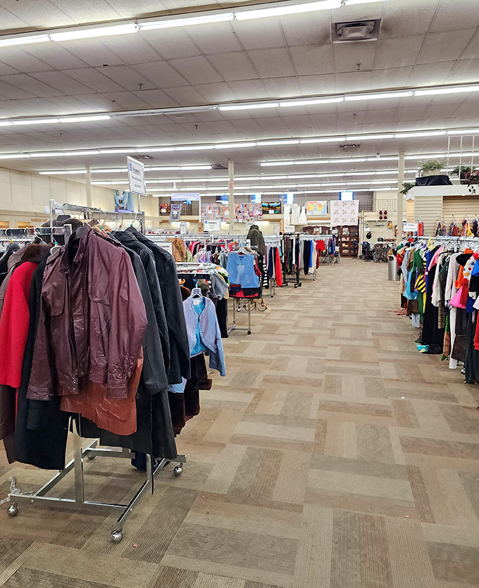 Racks upon racks of possibility! The clothing section stretches before you like a textile time machine, ready to transport your wardrobe across decades.