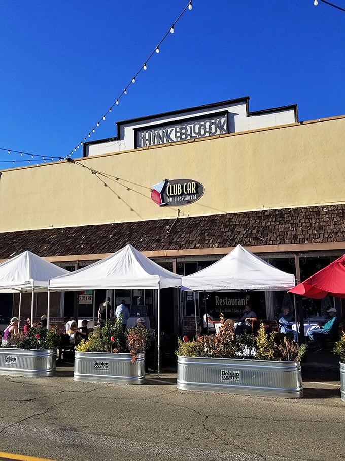 The Club Car Restaurant offers outdoor dining under string lights&mdash;where locals gather for comfort food that makes your grandmother's cooking seem merely adequate.