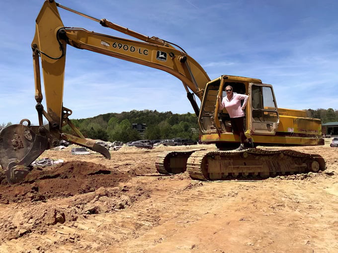 Heavy machinery dreams come true as a visitor tries her hand at operating a John Deere excavator. Sandbox skills finally paying off!