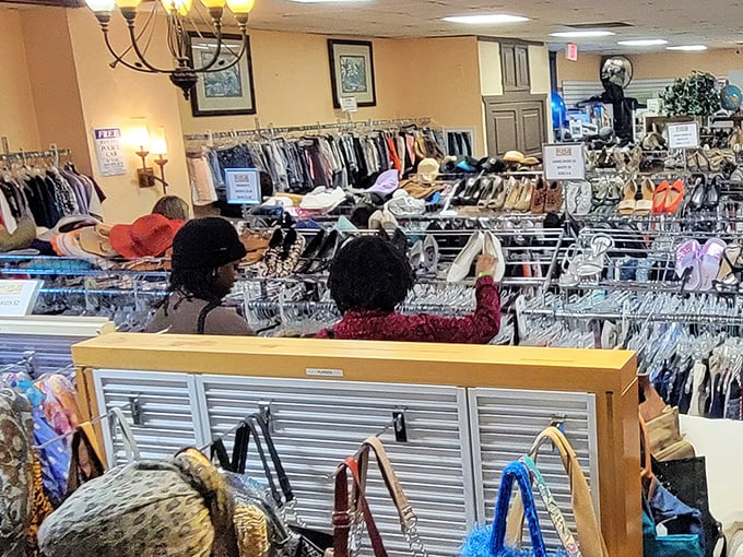 Rack after rack of possibilities await eager shoppers. The chandelier overhead adds an unexpected touch of elegance to this bargain paradise.