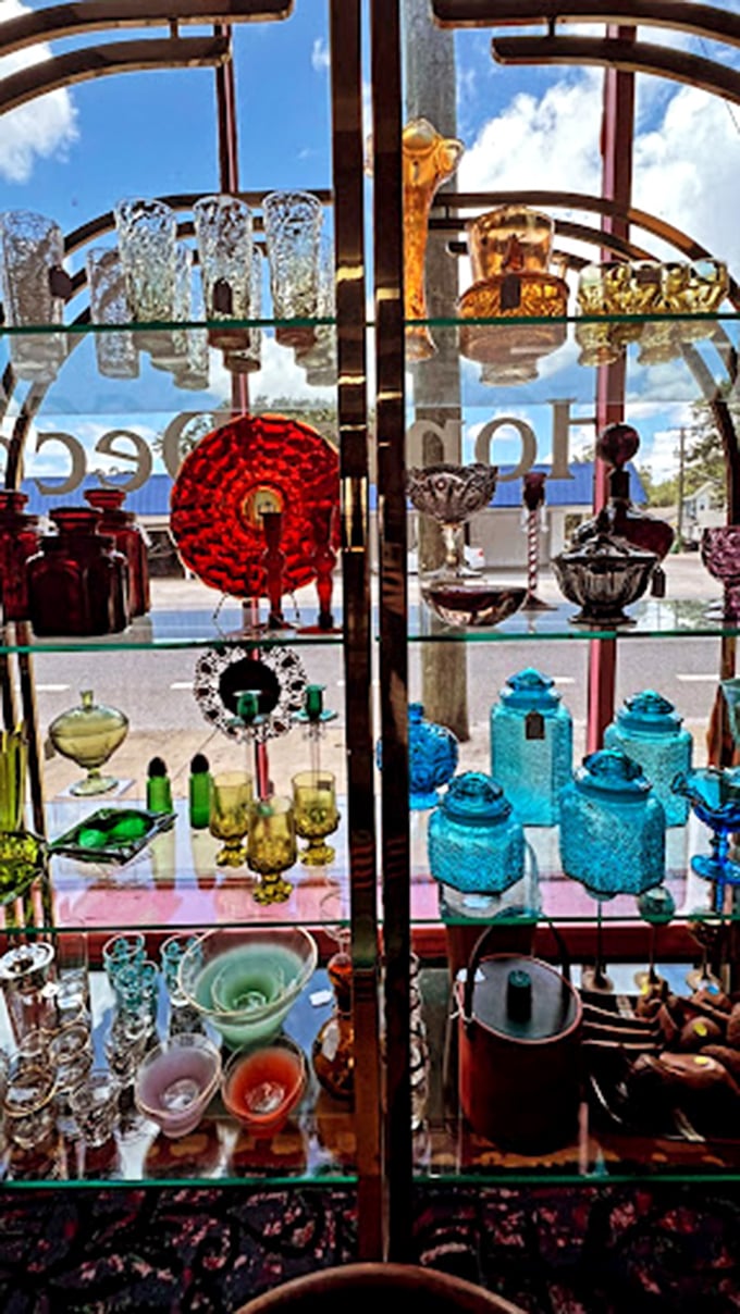 A kaleidoscope of vintage glassware catches the light like jewels. That turquoise decanter is practically begging to serve something Don Draper would approve of.