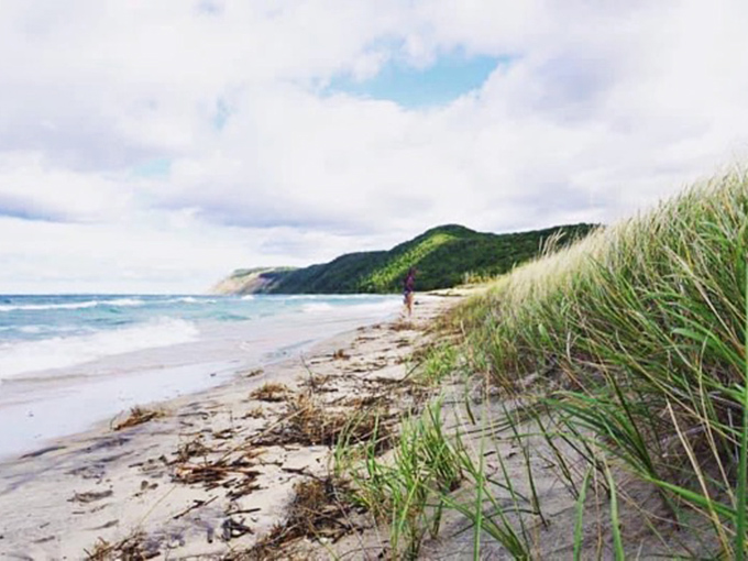Some beaches collect people; this one collects moments. The dune grass whispers secrets while Lake Michigan performs its endless blue symphony. 