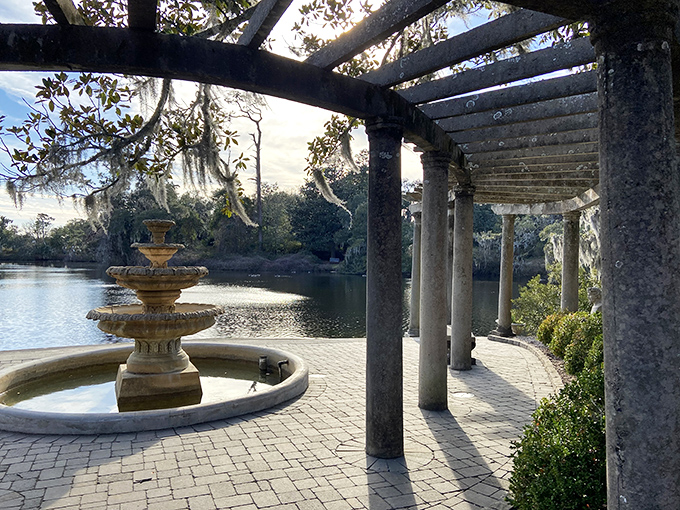 Classical columns frame this tranquil waterfront pergola, where Southern charm meets architectural elegance in a scene straight from a romance novel.