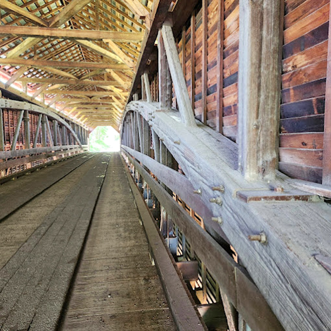 Sunlight plays hide-and-seek through the wooden slats, creating an ever-changing light show on the bridge's interior craftsmanship. 
