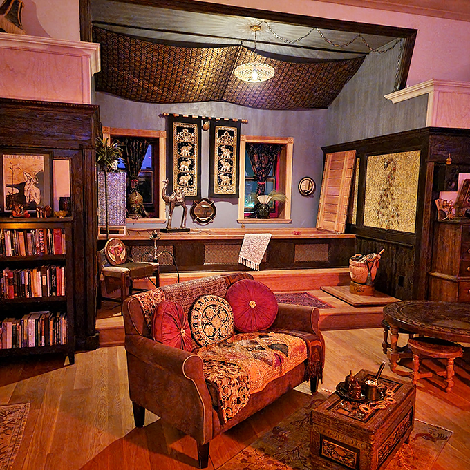 This cozy nook blends bohemian charm with Victorian sensibilities. The ornate ceiling and vibrant textiles create a space that's both inviting and mysteriously exotic.