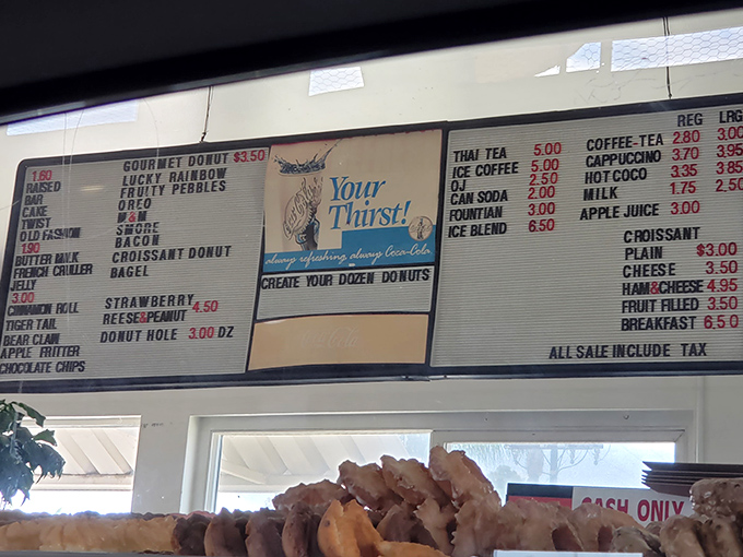 Menu board poetry: from Fruity Pebbles to Tiger Tails, each name promises a different journey into donut bliss.