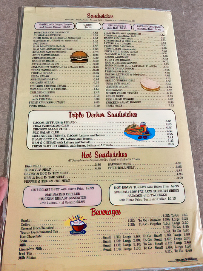 A menu that requires both hands and serious contemplation. The triple-decker sandwich section alone deserves its own ZIP code!