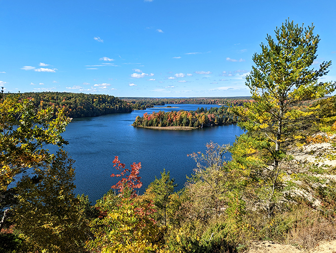 Nature's own masterpiece unfolds where autumn colors meet pristine waters in Michigan's hidden treasure chest.