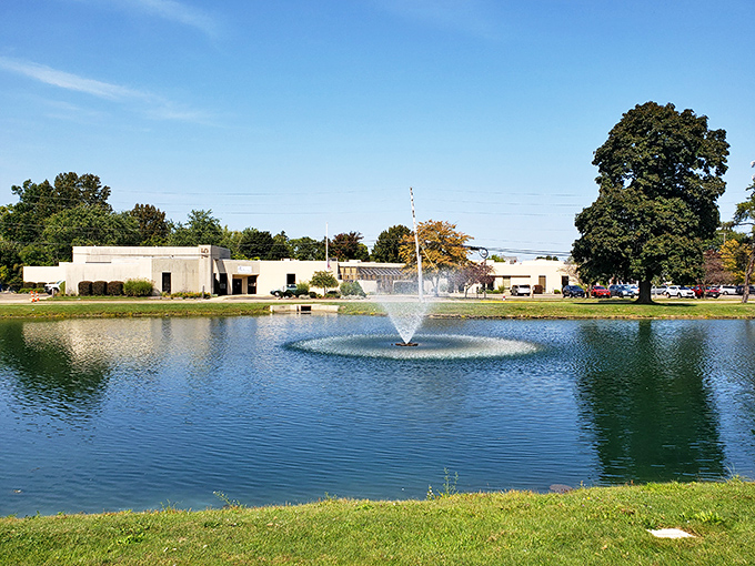 A serene fountain creates ripples across the reflecting pond. Nature's own mirror showing off the castle's grandeur from a refreshing perspective.