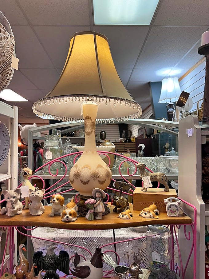 This pink display stand hosts a canine convention of porcelain pups, all supervised by that elegant beaded lamp standing guard above.