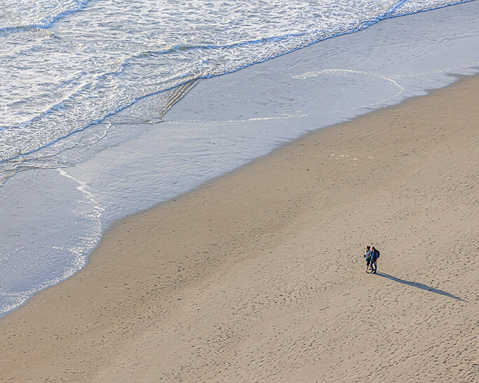 Two figures create their own private universe on an expanse of sand that seems to whisper, "Slow down, you've arrived."