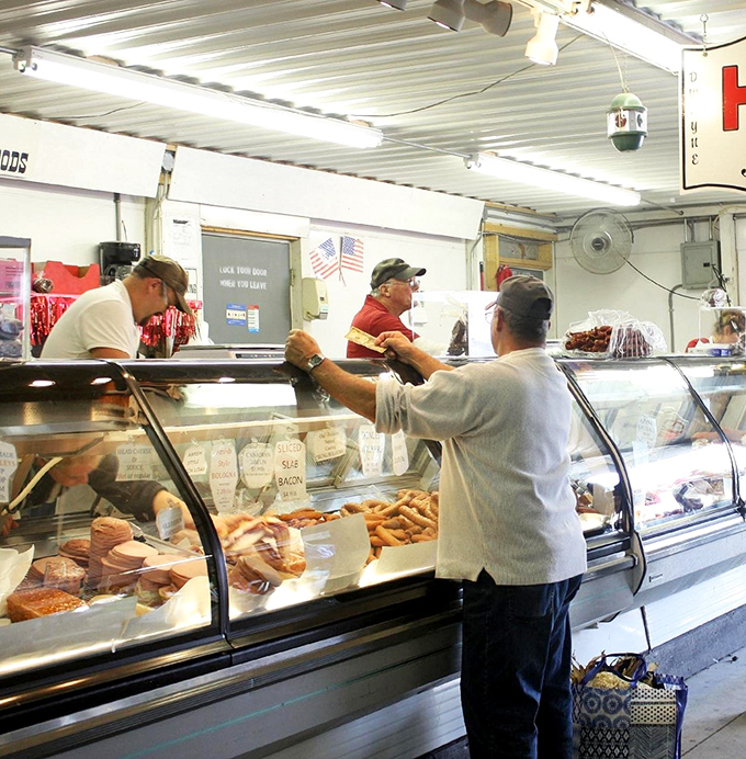 The universal language of smoked meats brings shoppers to a standstill. This butcher counter's display could make even the most dedicated vegetarian pause for a wistful sniff.