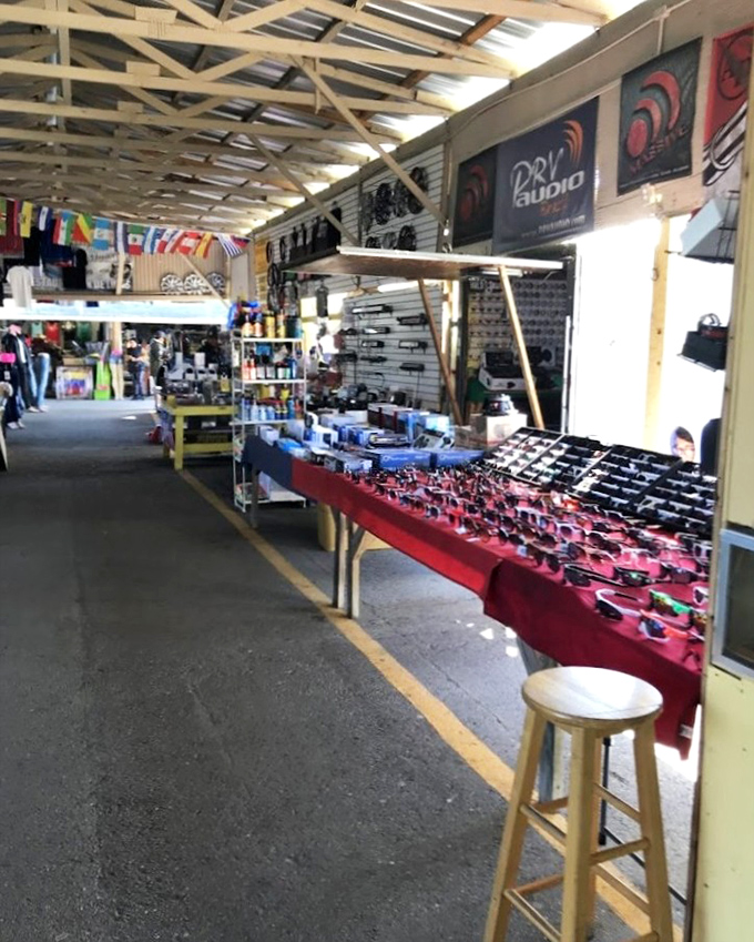 Audio equipment and sunglasses share space in this vendor's stall, where one person's obsolete technology becomes another's vintage find.
