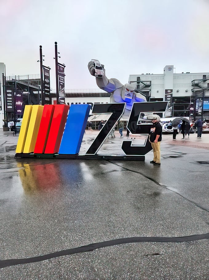 The NASCAR logo gets a monstrous upgrade as Miles peeks over the colorful display, like a curious giant checking out what all the excitement's about.