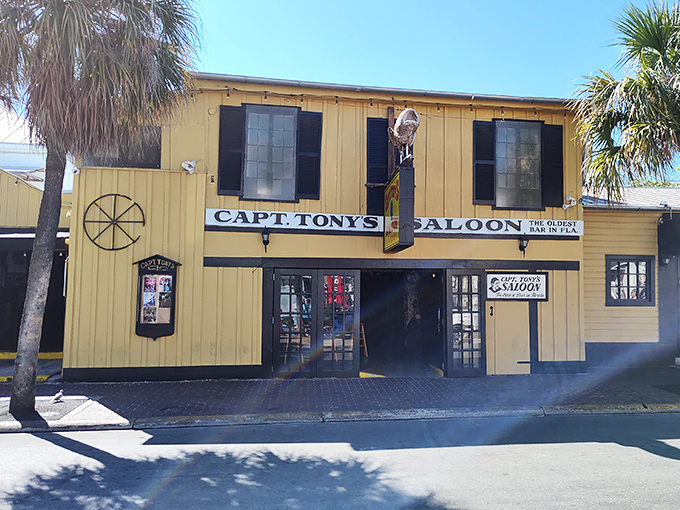 Captain Tony's stands proud in Key West sunshine, a yellow beacon calling to thirsty souls seeking authentic island vibes.