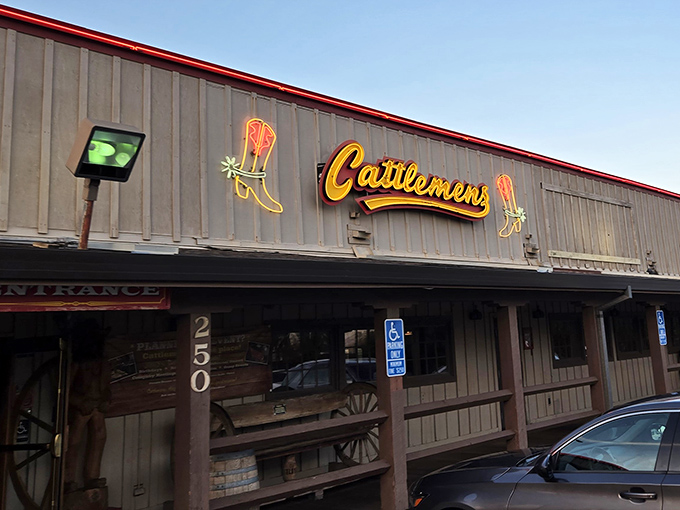 Those neon cowboy boots aren't just decoration - they're a promise that real Western hospitality awaits inside this steakhouse.