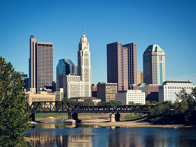 Columbus shows off its architectural personality against a brilliant blue sky. The capital city whispers, "You don't need a senator's salary to live well here."