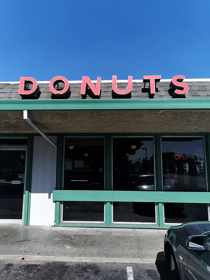 The bright red "Donut Nook" sign promises sweet relief to anyone passing by. No frills, just fulfillment in dough form.