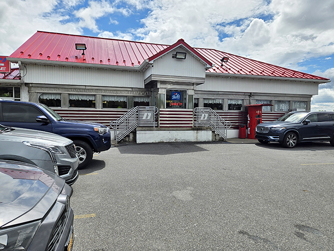 D's Diner's striking red roof and white exterior stand out like a beacon of hope for empty stomachs on the highway.