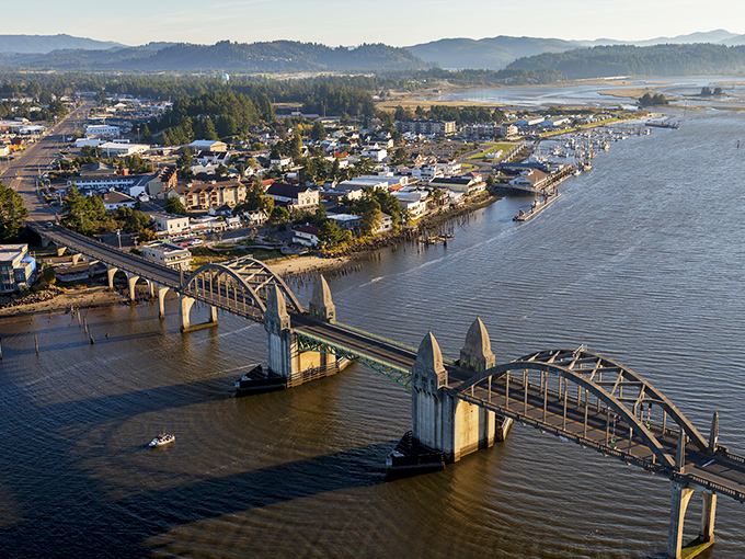 Florence's historic bridge arches gracefully over the Siuslaw River, a postcard-perfect gateway to affordable coastal living.