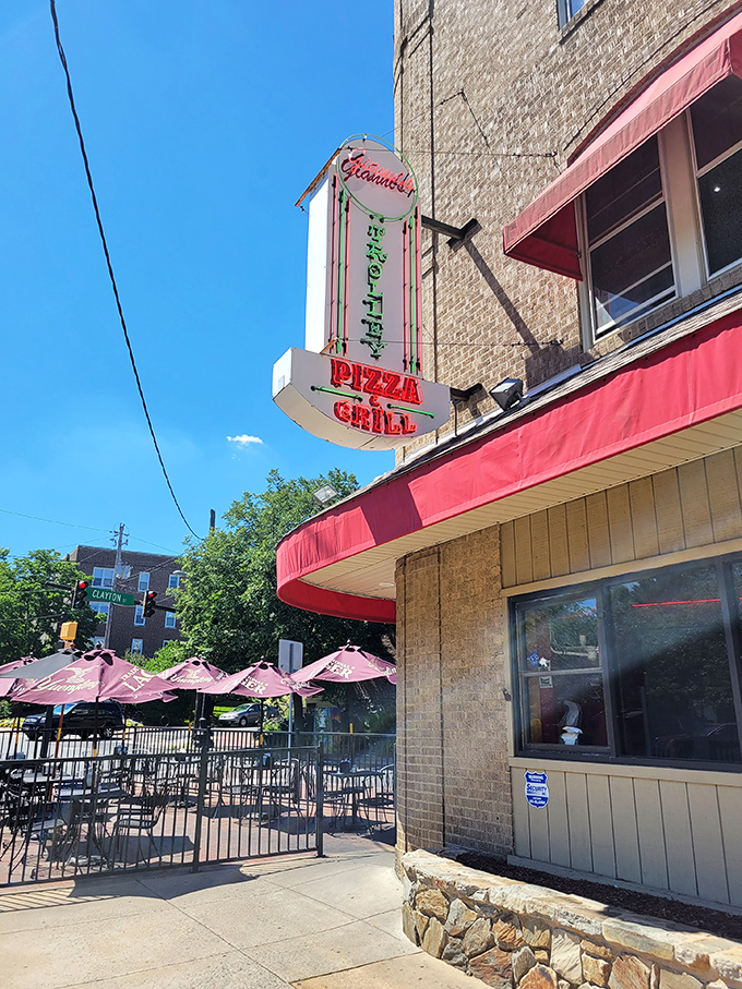 Gianni's classic neon sign glows with Italian promise. Those red awnings aren't just for show&mdash;they're guarding pizza perfection.