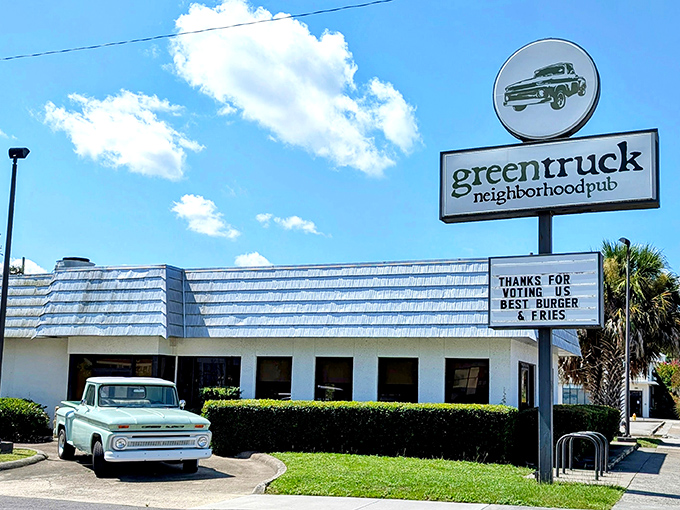 Green Truck Pub's charming exterior and vintage truck mascot &ndash; where farm-fresh meets comfort food in Savannah's hidden gem.