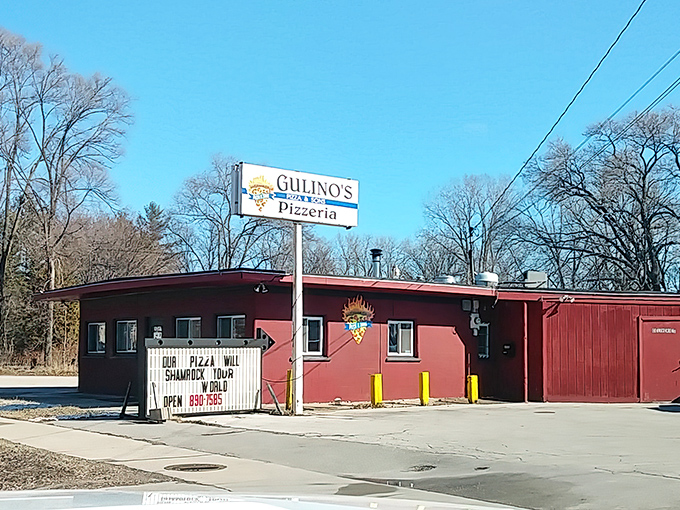 Gulino's modest red building houses pizza magic that locals have treasured for generations. That sign's humor hints at the personality inside!