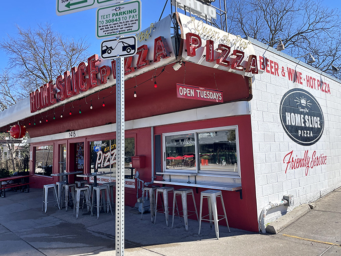 Home Slice Pizza: That red and white facade is like a beacon for pizza lovers. The metal stools outside are calling your name! 