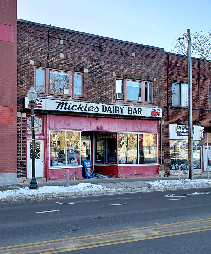 Mickies Dairy Bar stands frozen in time, when Pepsi signs were art and pink storefronts promised honest food without pretense.