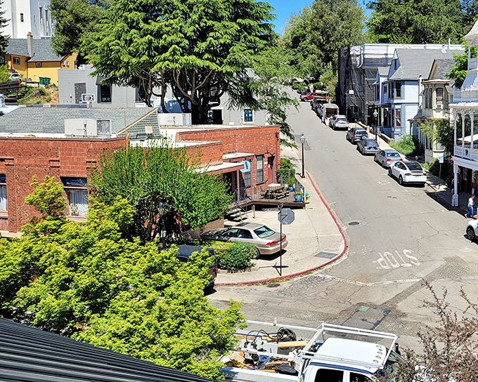 Nature's embrace! Nevada City's colorful buildings nestle into verdant hillsides like a Hallmark movie set where retirees discover second acts and antique treasures.