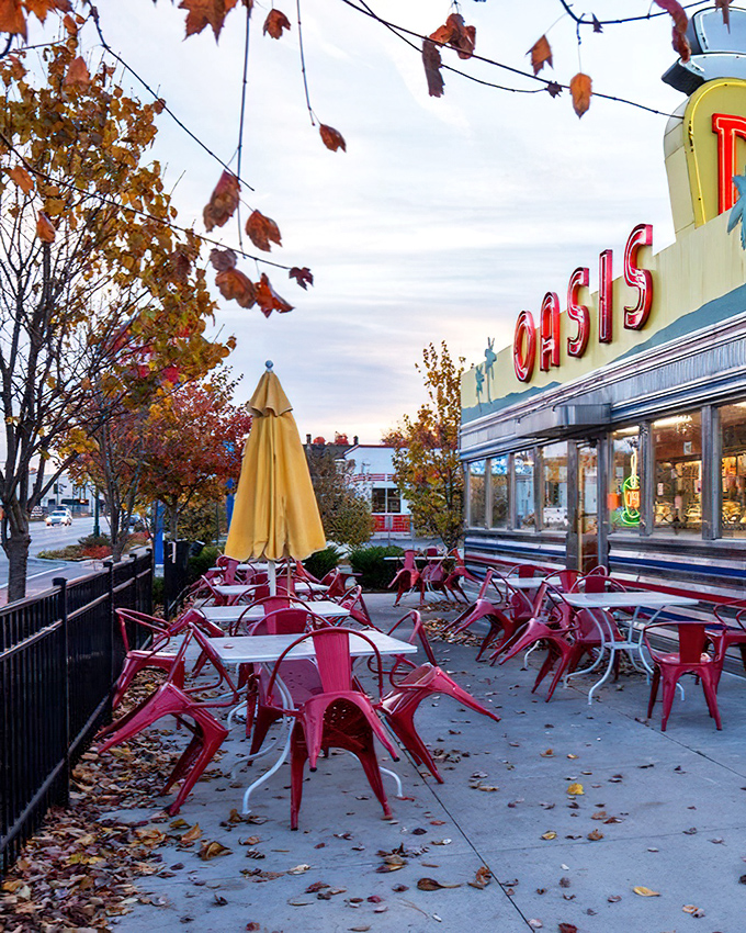Oasis Diner: Fall foliage meets chrome-plated dreams. Those red chairs are calling your name louder than your stomach.