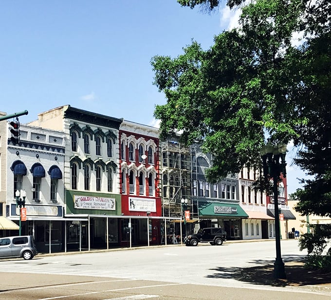 Paris without the passport! These candy-colored buildings stand shoulder-to-shoulder like old friends, each one with character lines that tell tales sweeter than Tennessee honey.