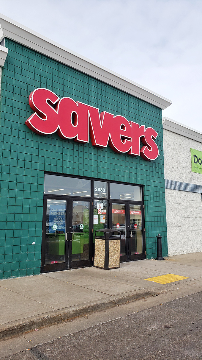 Savers' vibrant green storefront pops against the urban landscape. A retail oasis where vintage treasures and modern bargains peacefully coexist.