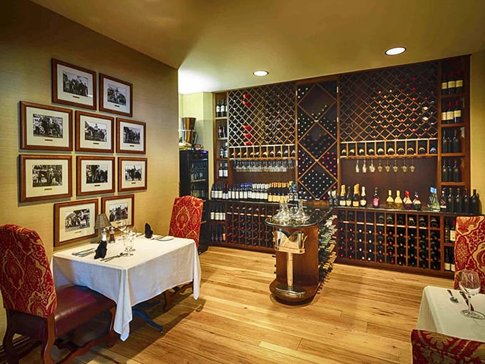 Wine lovers, rejoice! 1875's impressive collection awaits in this intimate dining nook where vintage photographs tell stories of meals past.