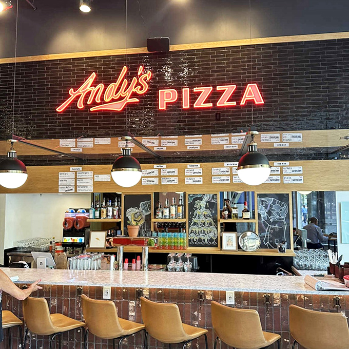 That glowing "Andy's Pizza" sign is like a lighthouse guiding hungry sailors to cheesy, crispy salvation. 