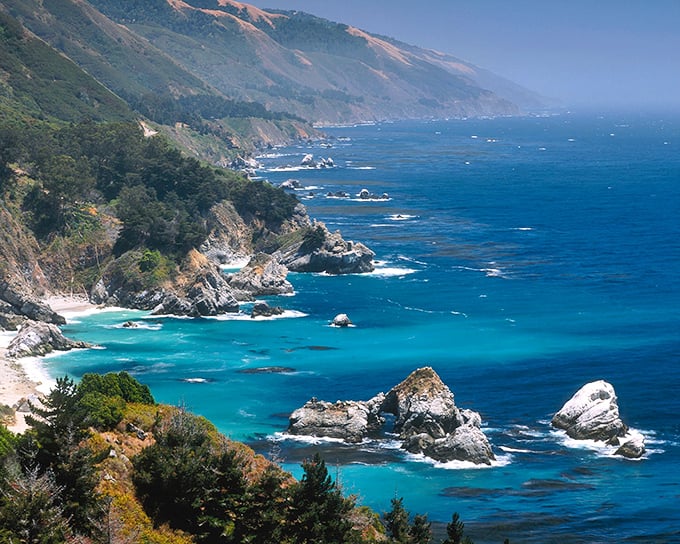A waterfall that empties directly onto a beach? It's like Nature decided to create the perfect screen saver right here in California.