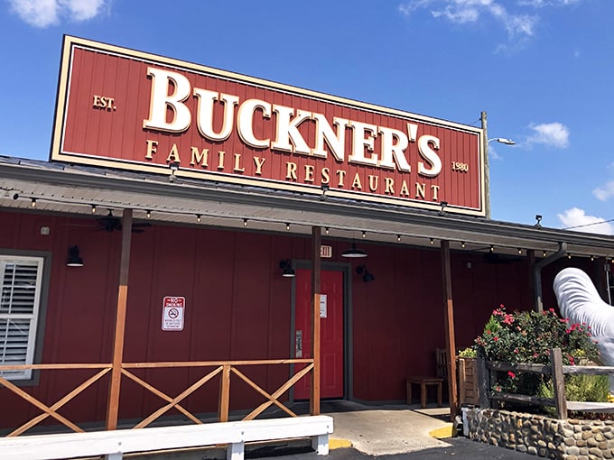 Red barn aesthetics with a porch that practically whispers "come sit a spell" &ndash; Southern hospitality in architectural form.