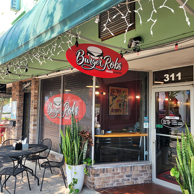 The sidewalk view of BurgerRobs showcases its charming storefront. Those brick walls have witnessed countless burger epiphanies.