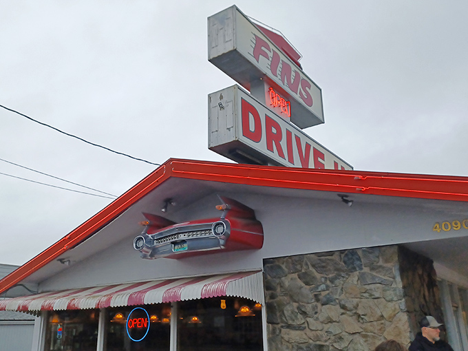 That classic car silhouette above Fins Drive-In isn't just decoration&mdash;it's a beacon guiding hungry souls to burger nirvana.