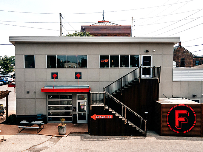 That staircase isn't just an entrance &ndash; it's a red-lettered invitation to ascend into Detroit-style pizza heaven.
