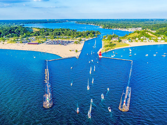 Sailboats glide through the iconic channel, golden beaches stretch along the shoreline, and the red lighthouse welcomes all to this picturesque lakeside gem.