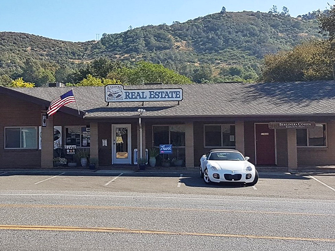 The Iron Door Saloon beckons with promises of cold drinks and warm conversation in a town where rush hour means three cars at once.