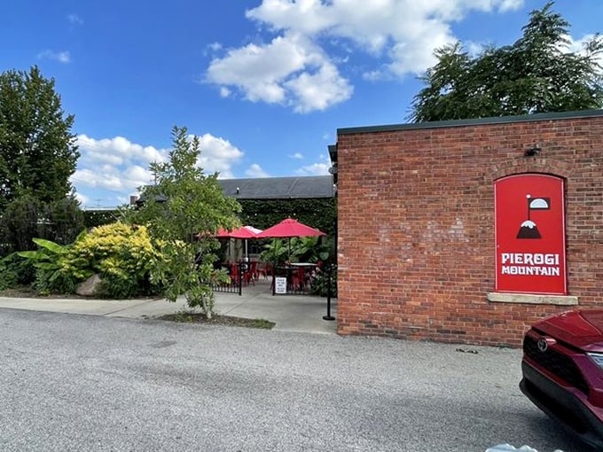 Red umbrellas and brick walls create the perfect urban retreat for savoring pillowy pierogies on a sunny Ohio afternoon.