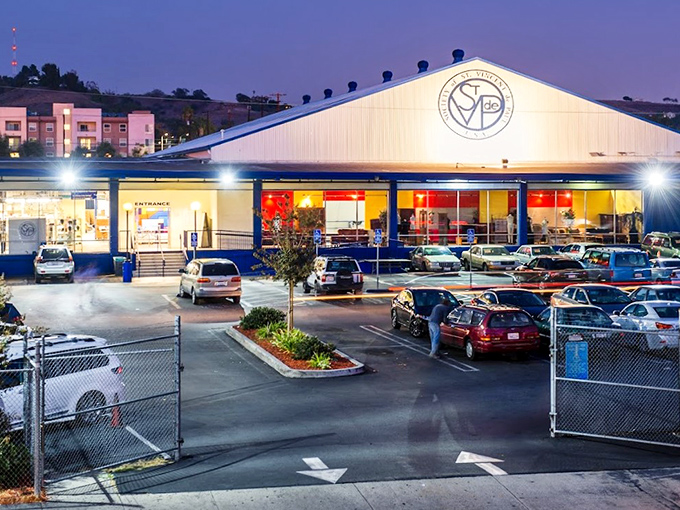 By night, this thrift store transforms into a glowing beacon of bargain-hunting possibilities.