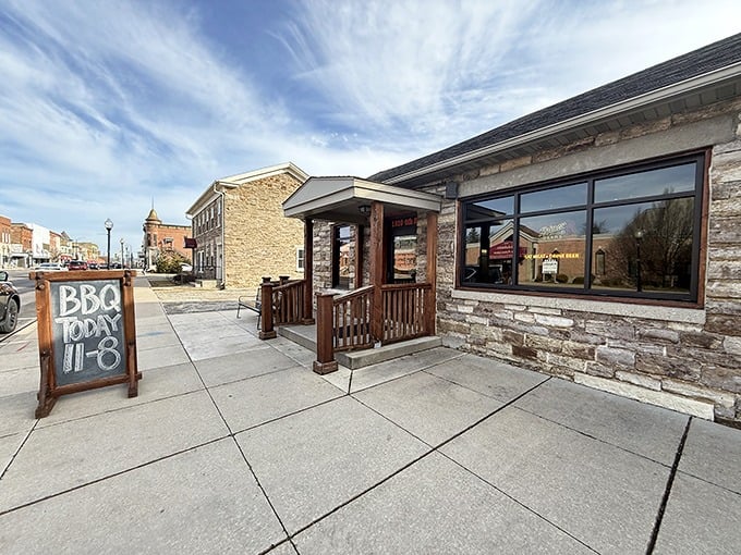 The sidewalk view of Stone Jug Barbeque offers picnic tables where strangers become friends over plates of smoky goodness.
