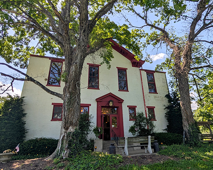 Those red shutters and white clapboard siding whisper tales of homework and hot lunches from a simpler time.