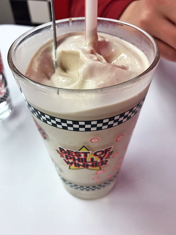 Two straws stand guard over a milkshake mountain that could make Ben & Jerry weep with envy.